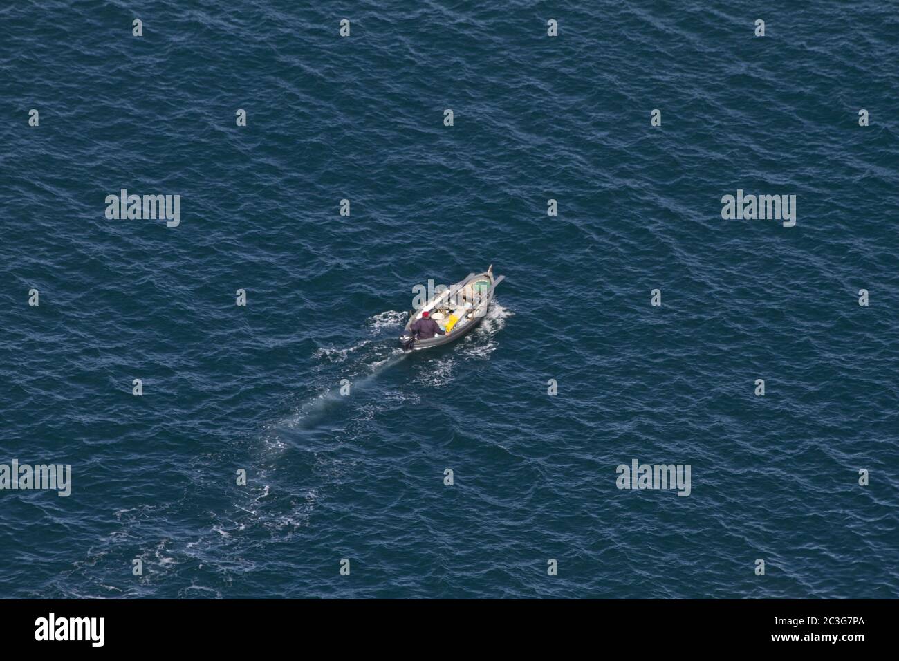 High angel shot of a fisher's boat in the blue sea Stock Photo - Alamy