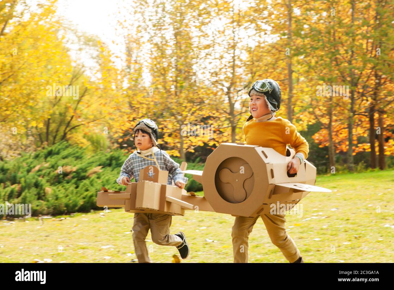 Two boys play to fly Stock Photo - Alamy