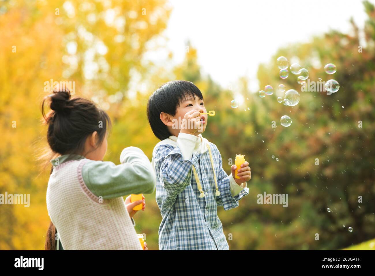 Happy children blow bubbles in the park Stock Photo - Alamy