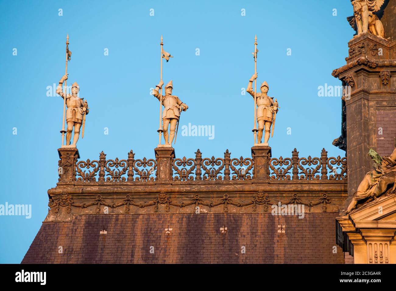 Low angle shot of old statues on top of a City hall building in Paris ...