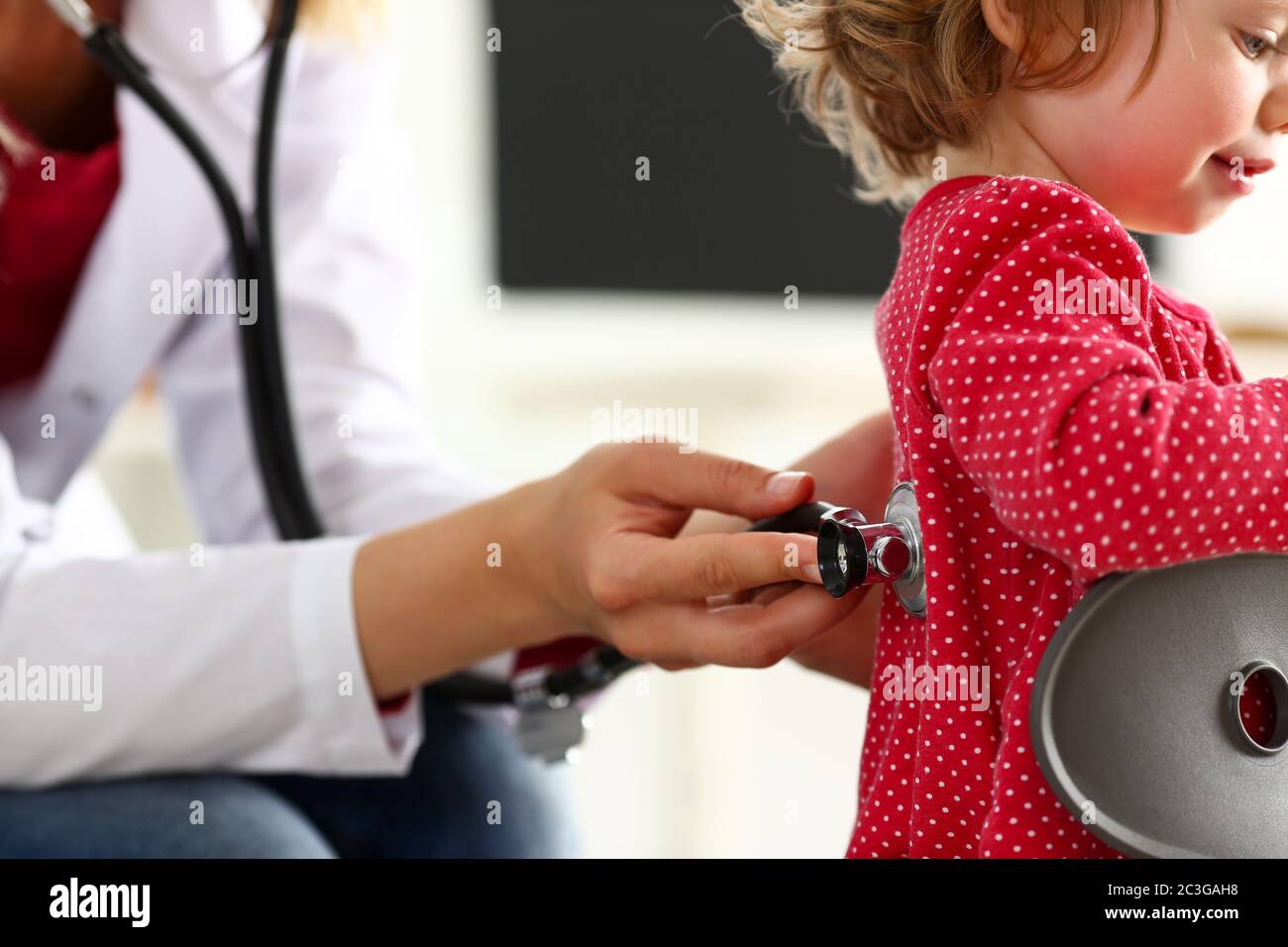 Little child with stethoscope at doctor reception Stock Photo - Alamy