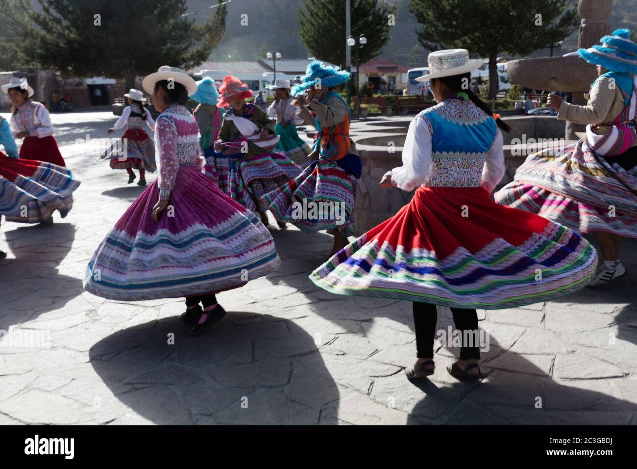 Peruvian girls with typical Andean costumes dancing in the main square ...