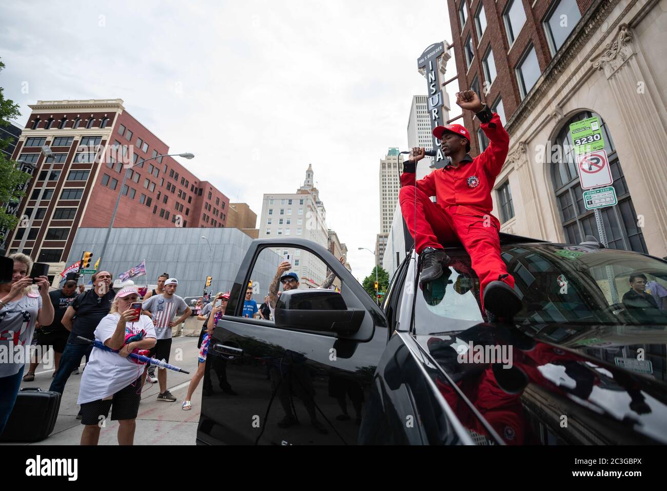 Tulsa, Oklahoma, USA. 19th June, 2020. A man leads a crowd of Trump ...