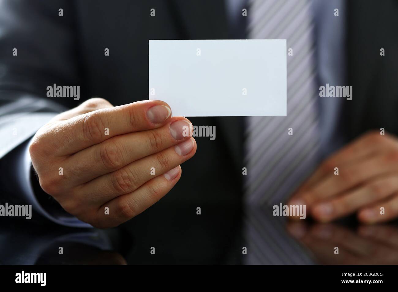 Male arm in suit give blank calling card to visitor Stock Photo - Alamy