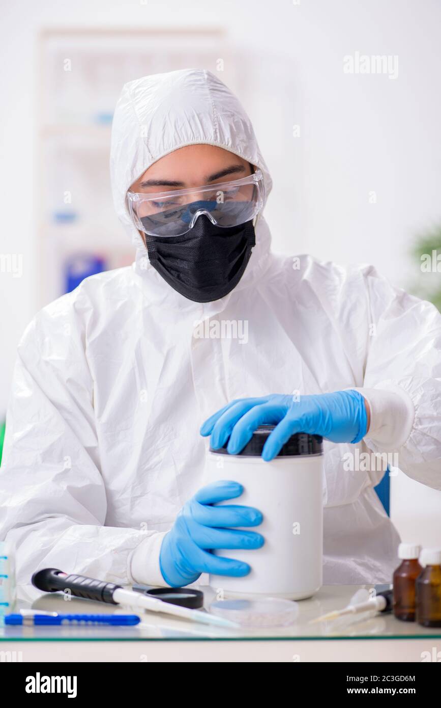 Young male chemist working in medicine lab Stock Photo - Alamy