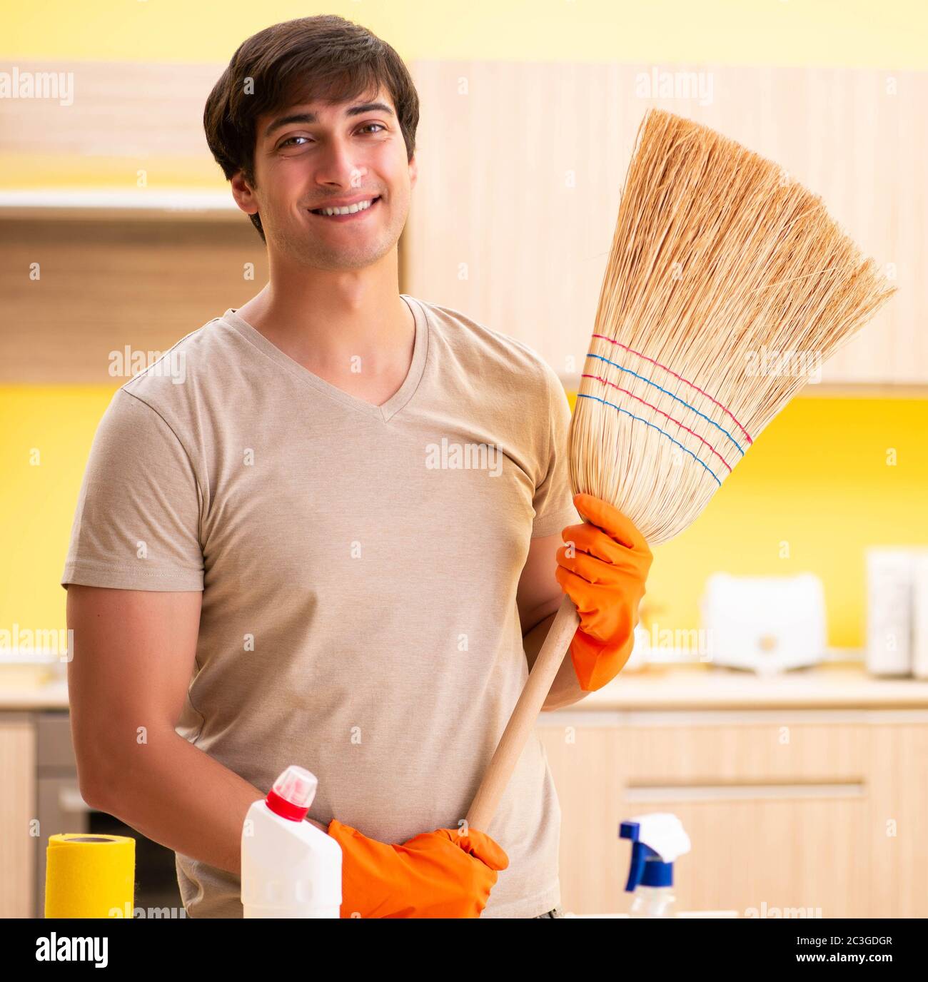Single man cleaning kitchen at home Stock Photo - Alamy