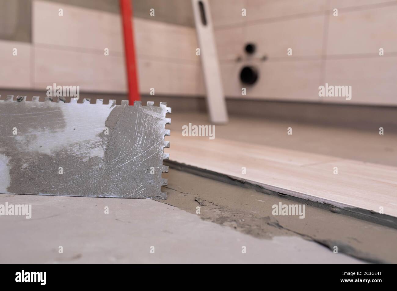 Hand tool. Metal trowel with square teeth cut out. A tool used for ...