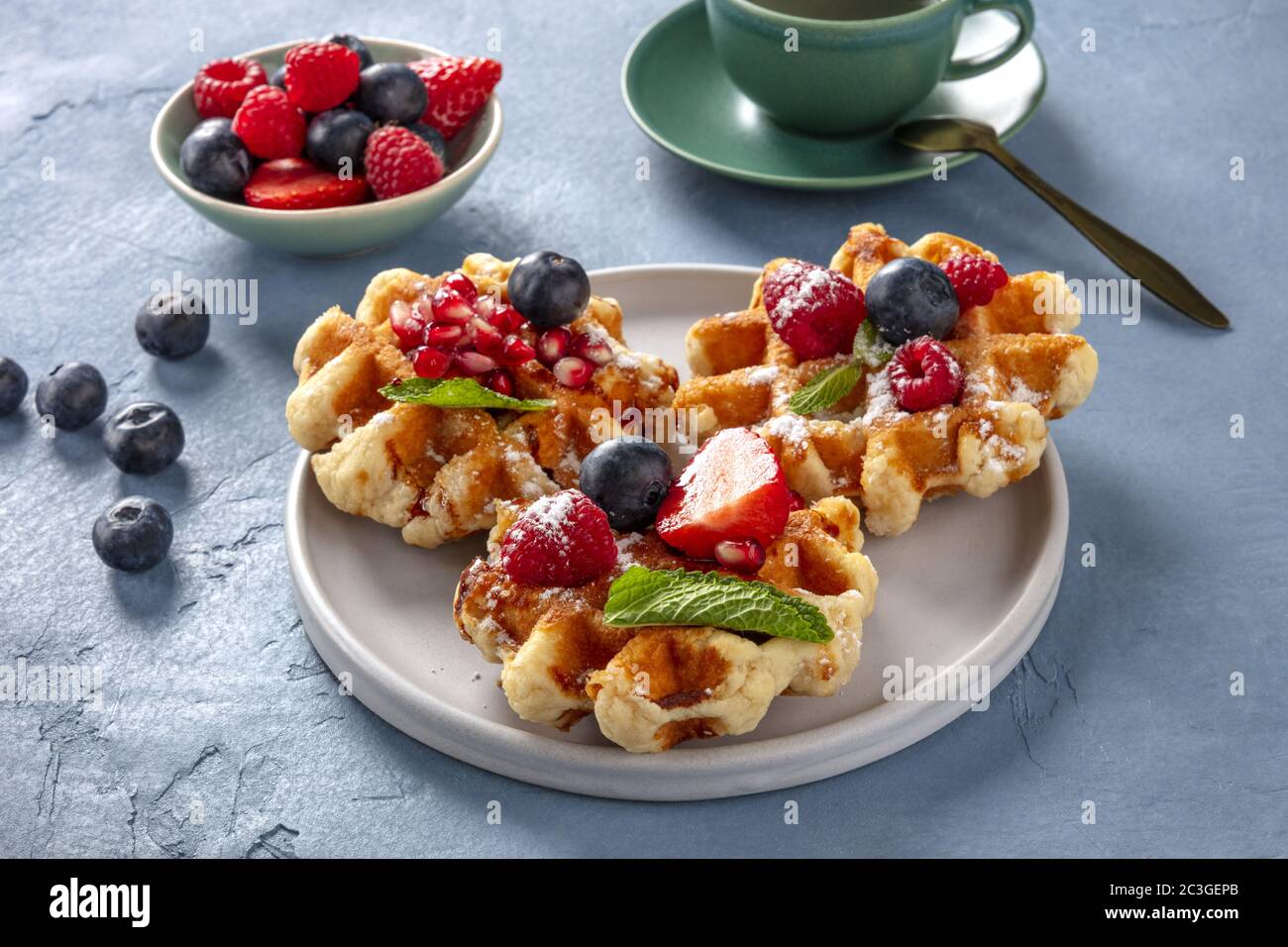 Belgian waffles with fresh fruit and mint leaves, a delicious breakfast ...