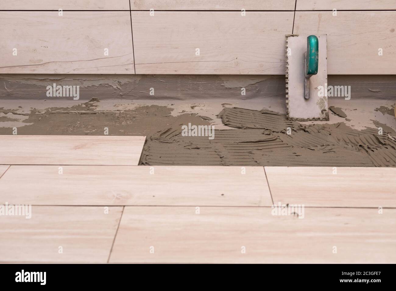 Hand tool. Metal trowel with square teeth cut out. A tool used for ...