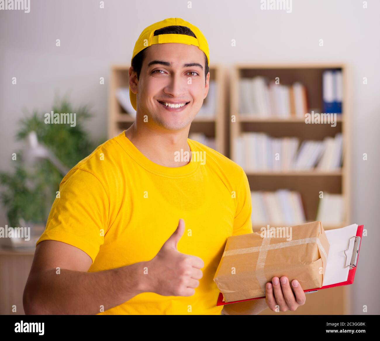 Delivery man delivering parcel box Stock Photo - Alamy