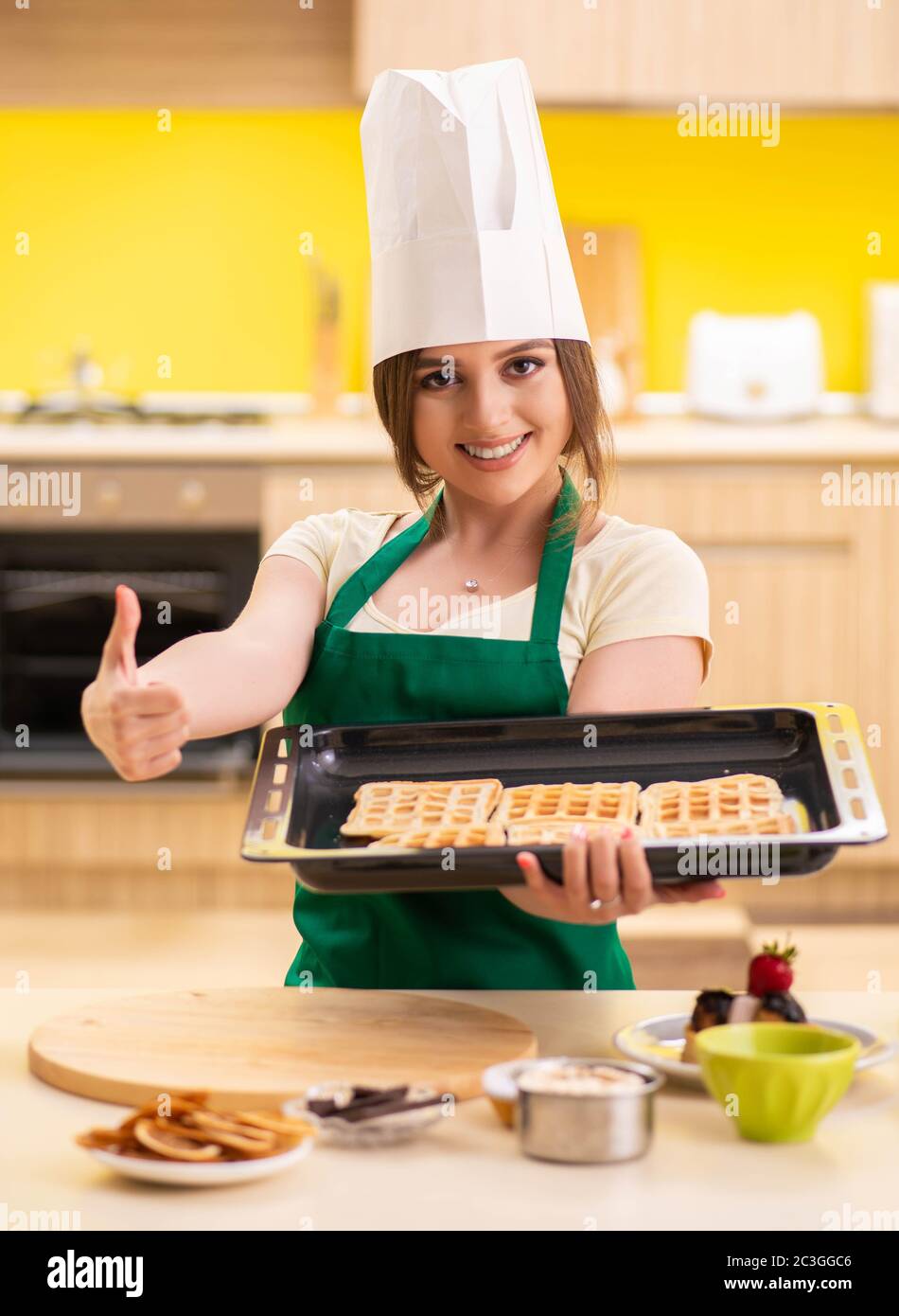 Young cook cooking cakes in the kitchen Stock Photo - Alamy