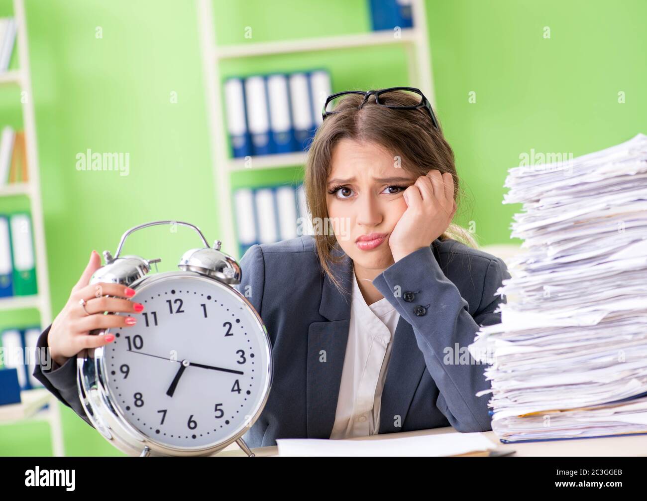 Young woman and paperwork and clock hi-res stock photography and images ...