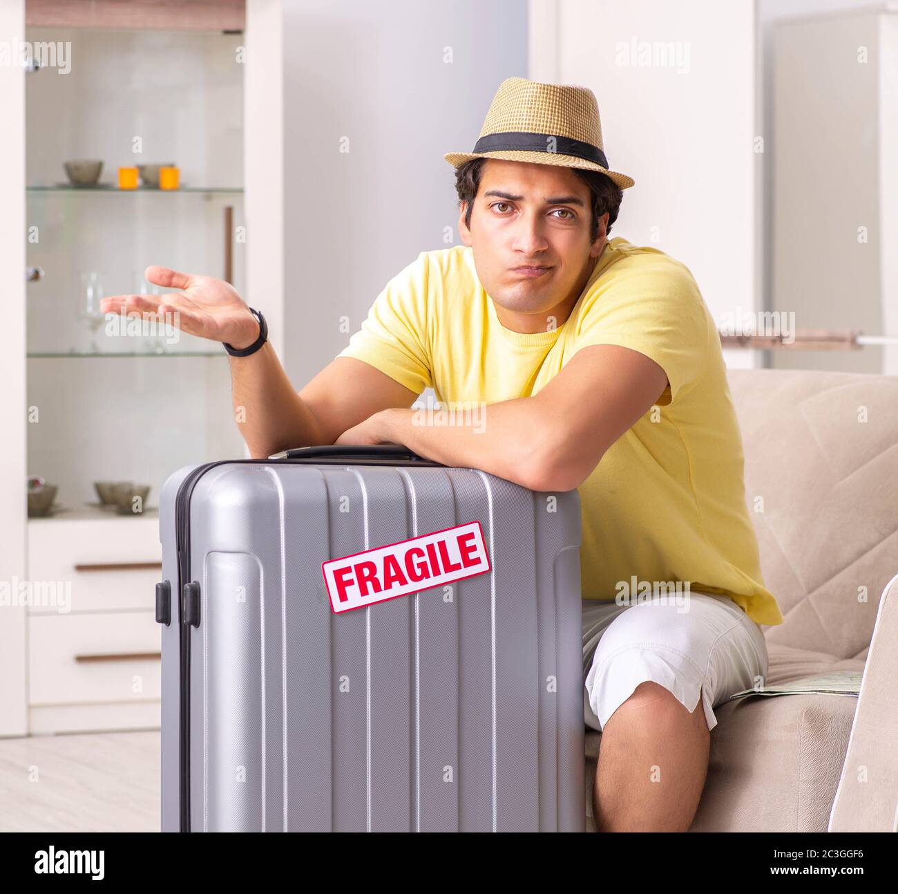 Man going on vacation with fragile suitcases Stock Photo - Alamy