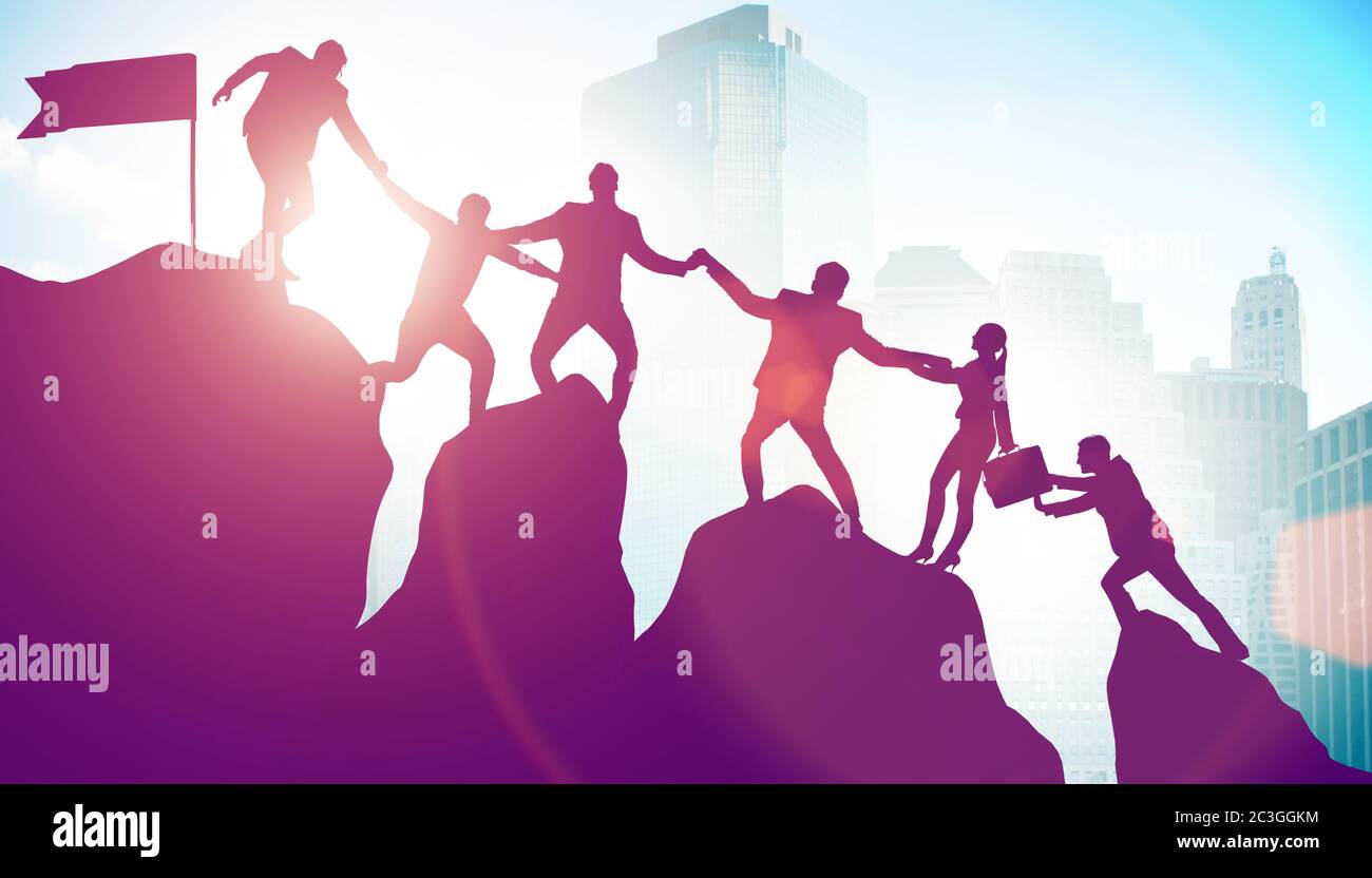 Concept of teamwork with team climbing mountain top Stock Photo - Alamy