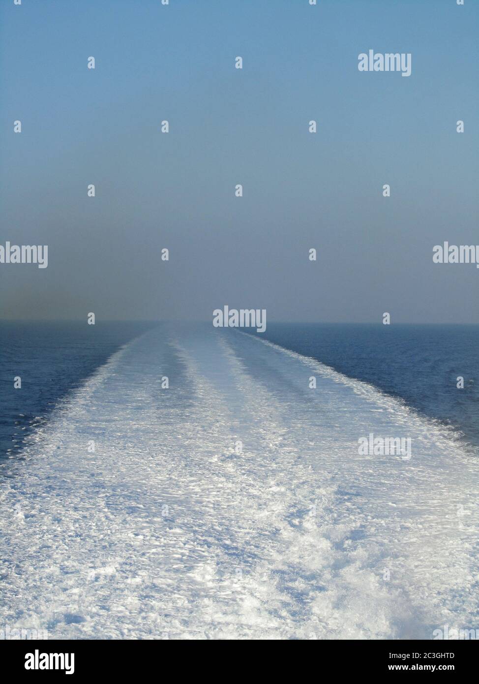 Vertical shot of a long wake in the sea made by a catamaran Stock Photo ...