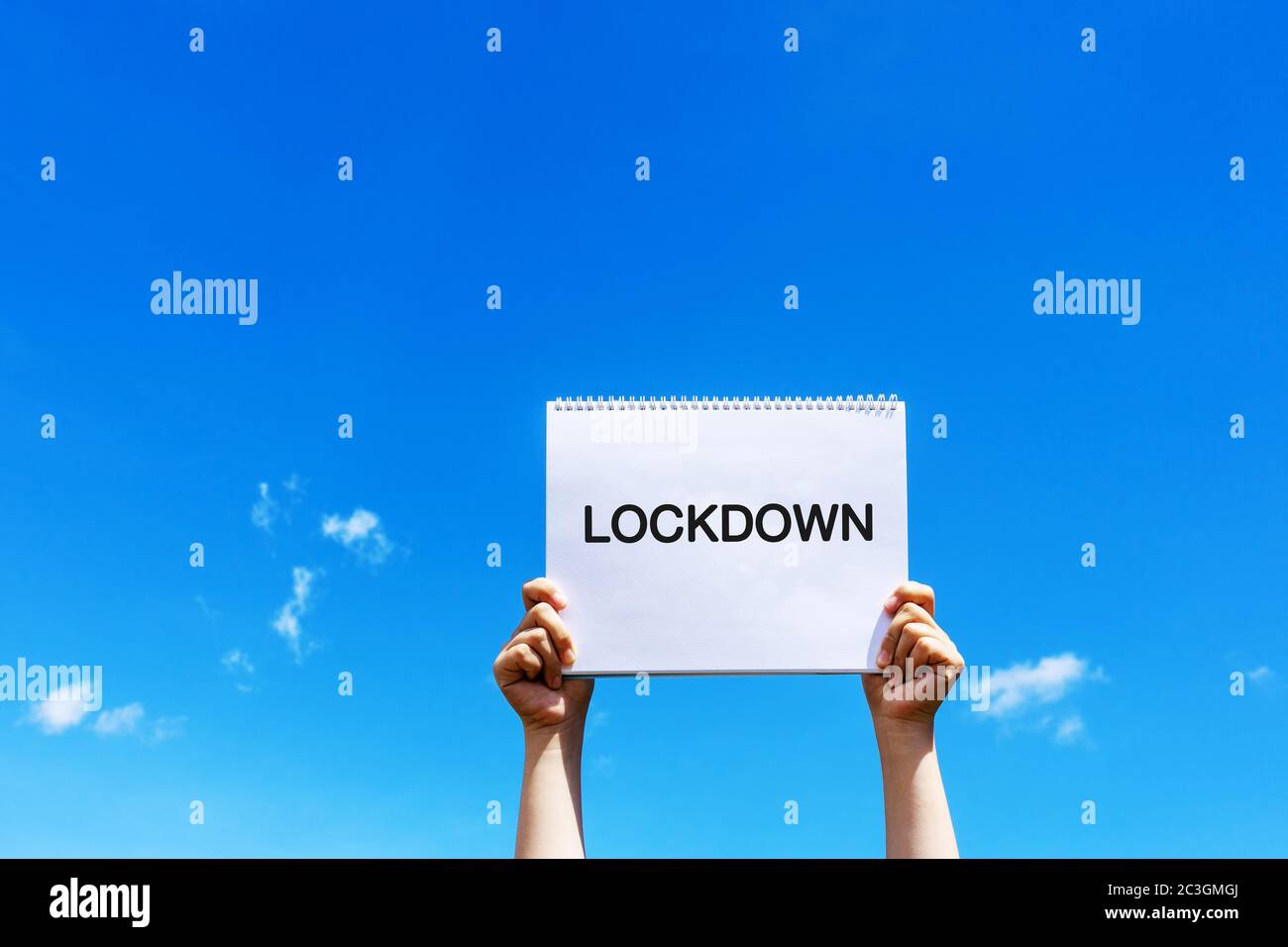 Hands holding paper note with Lock down text, blue sky background Stock ...