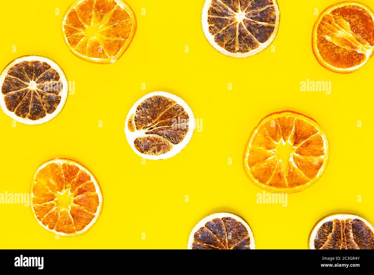 Dried slices citrus pattern on bright yellow background Stock Photo - Alamy