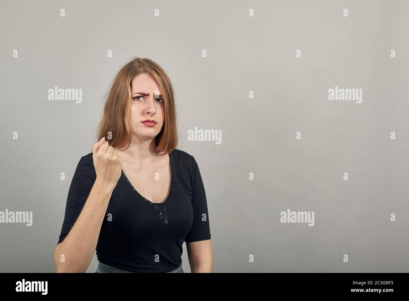 Angry and aggressive, shaking fist in a threatening way, domestic ...