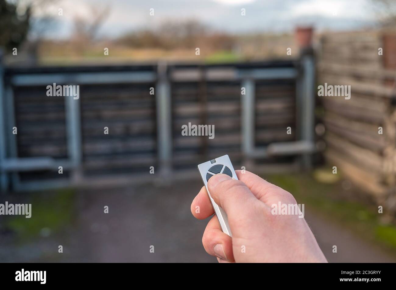 Opening a swing gate with automatic gate opener and a remote control ...