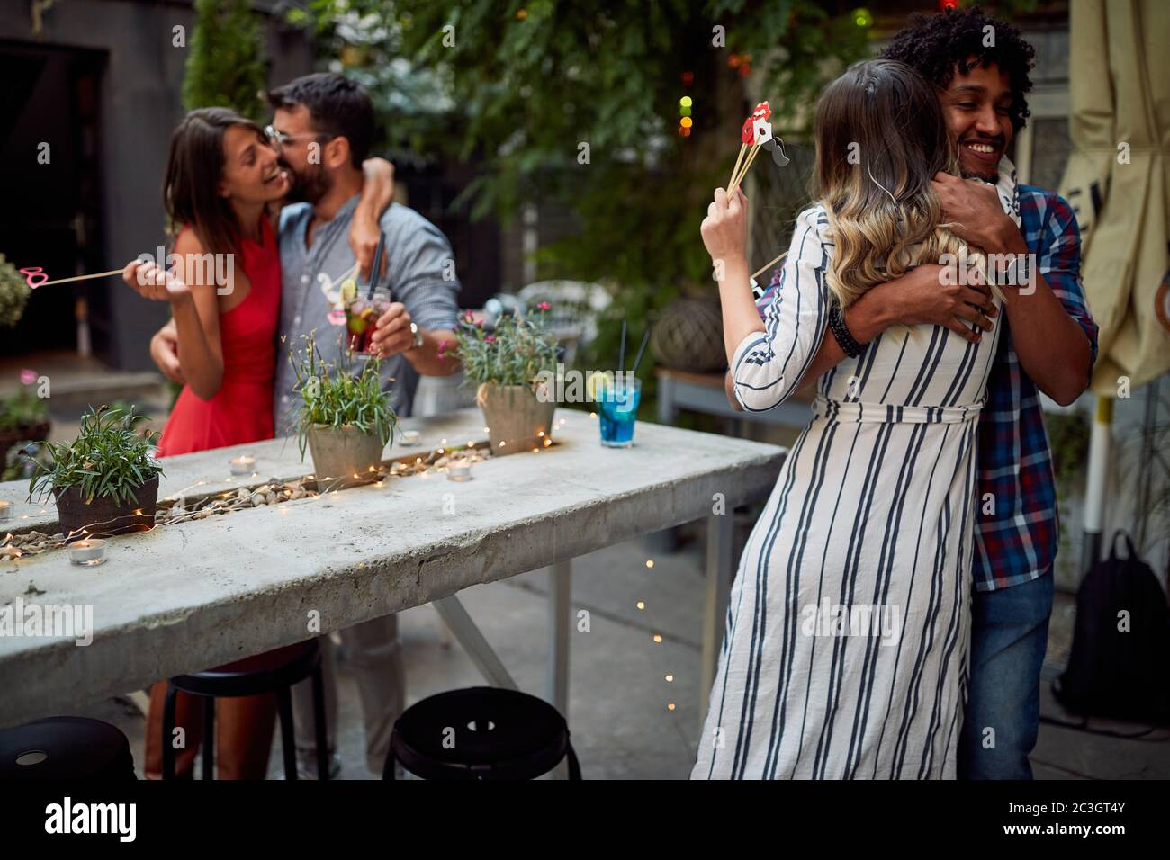 Young couples in lovely hug at a party Stock Photo - Alamy