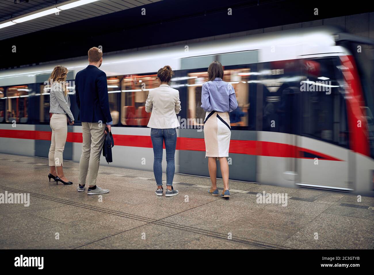 Group of commuters waiting for a metro transportation to get to work ...