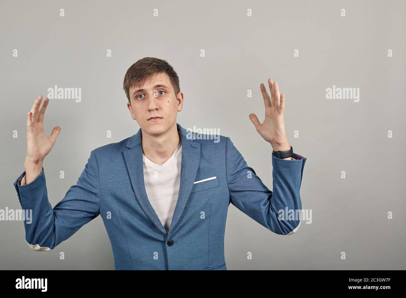 Shapes big object with two hands, gasps from surprise, holding palms in ...