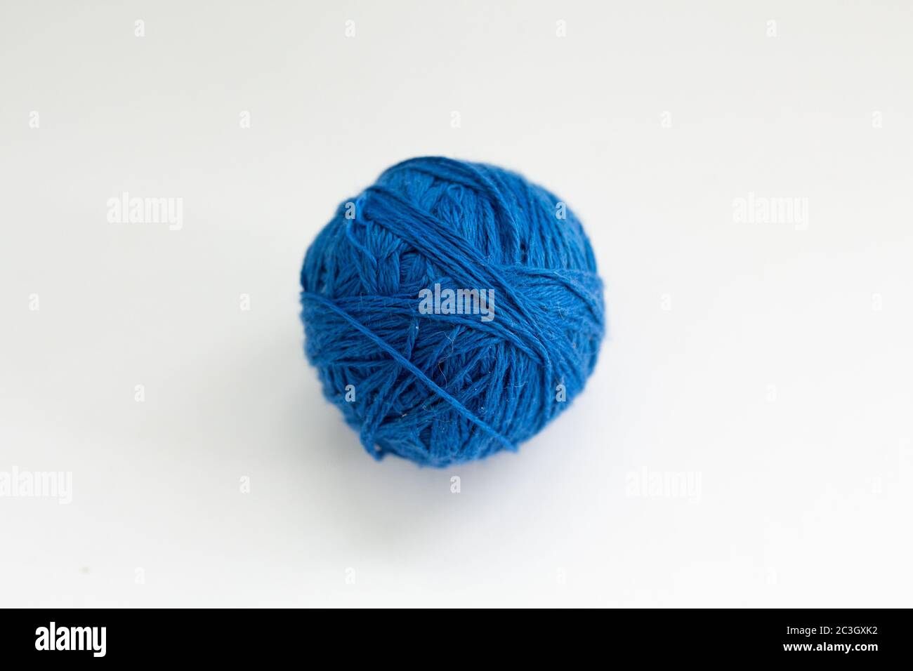 ball of blue thread on white background Stock Photo - Alamy