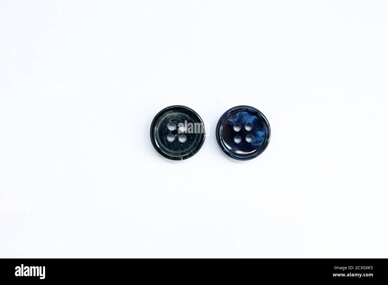 black buttons for clothes on white background Stock Photo - Alamy