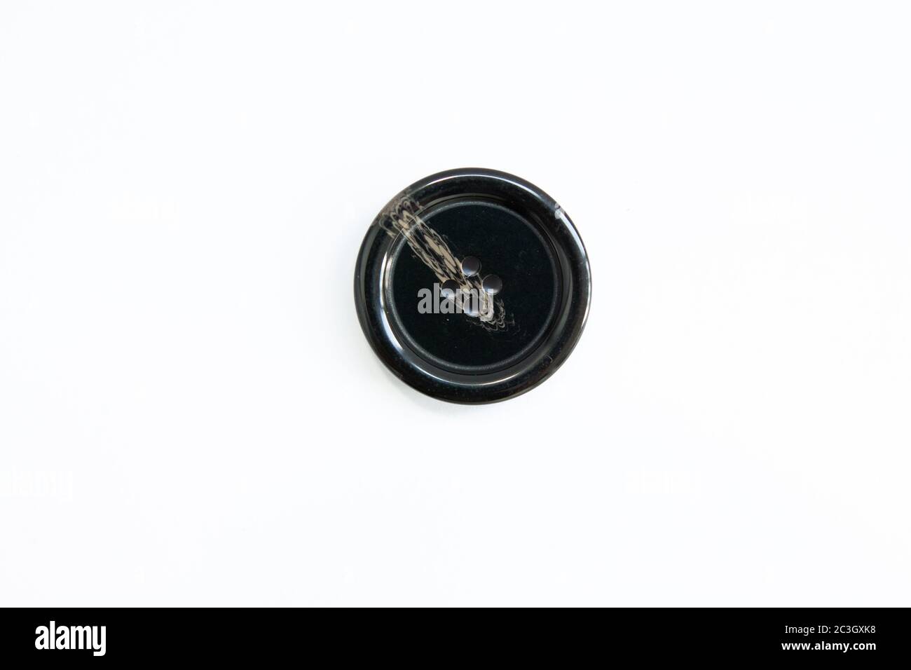 black buttons for clothes on white background Stock Photo - Alamy