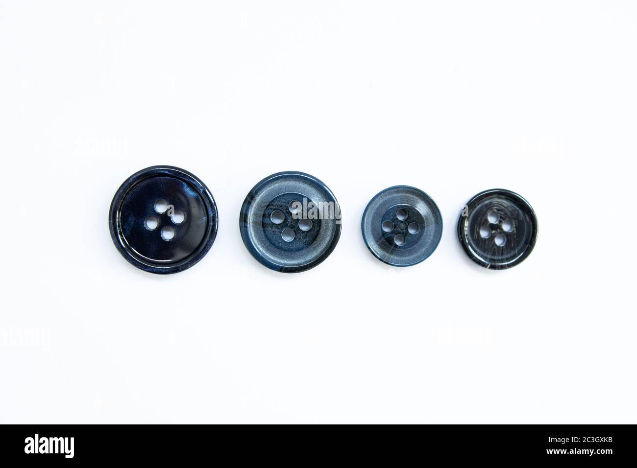 black buttons for clothes on white background Stock Photo - Alamy