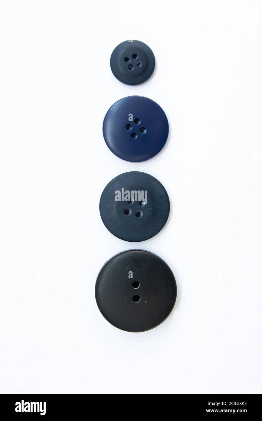 black buttons for clothes on white background Stock Photo - Alamy