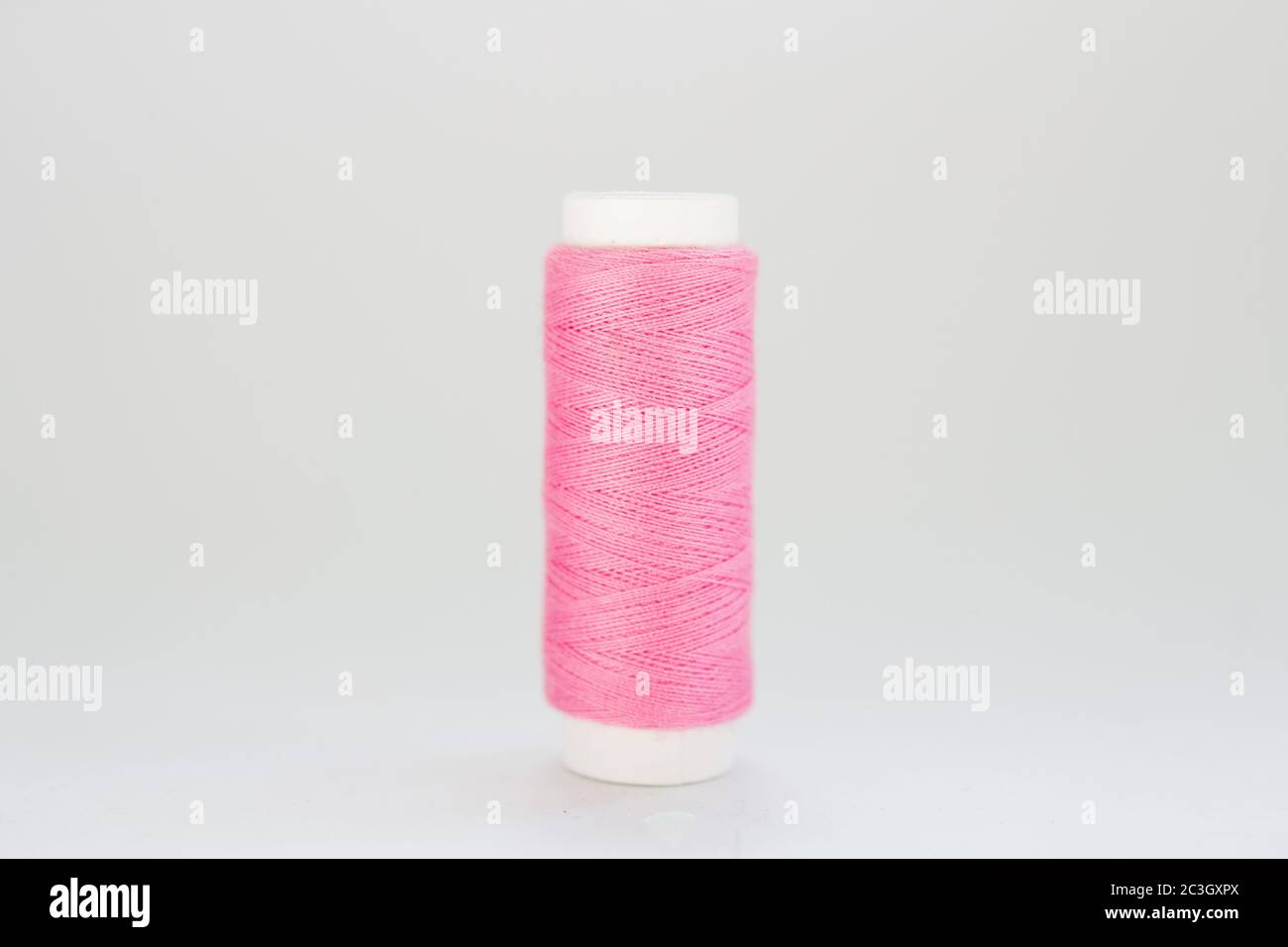pink threads on white background Stock Photo - Alamy