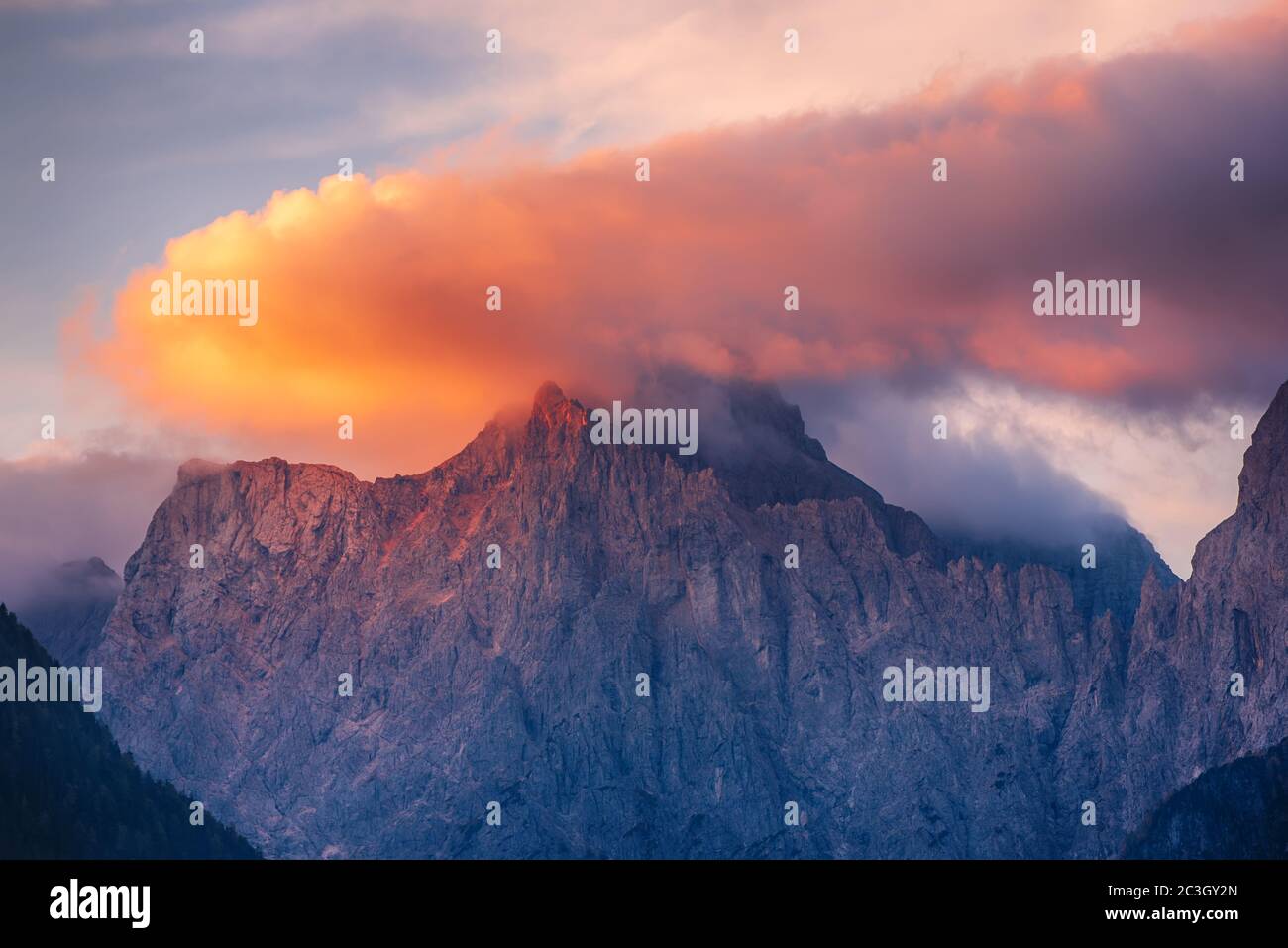 Triglav mountain peak at sunrise with beautiful clouds in morning light ...
