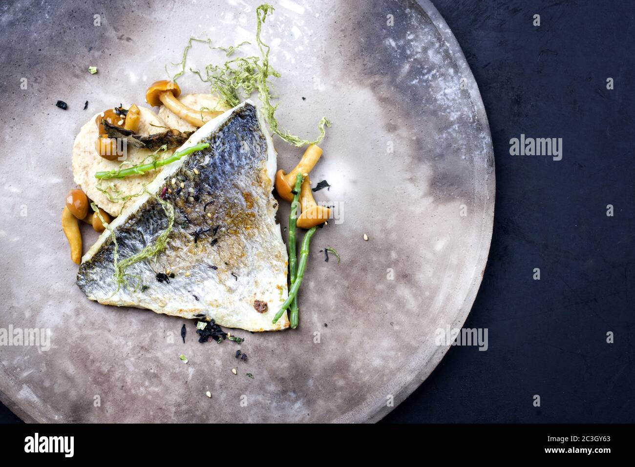Gourmet fried gilthead fish filet with sliced dumpling Stock Photo - Alamy