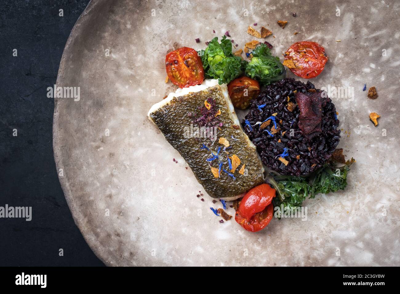 Gourmet fried European skrei cod fish filet with kalette and black ...