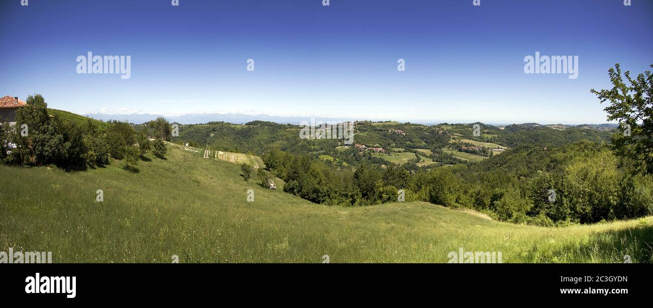 Panoramic shot of hills covered in greenery under the sunlight and a ...