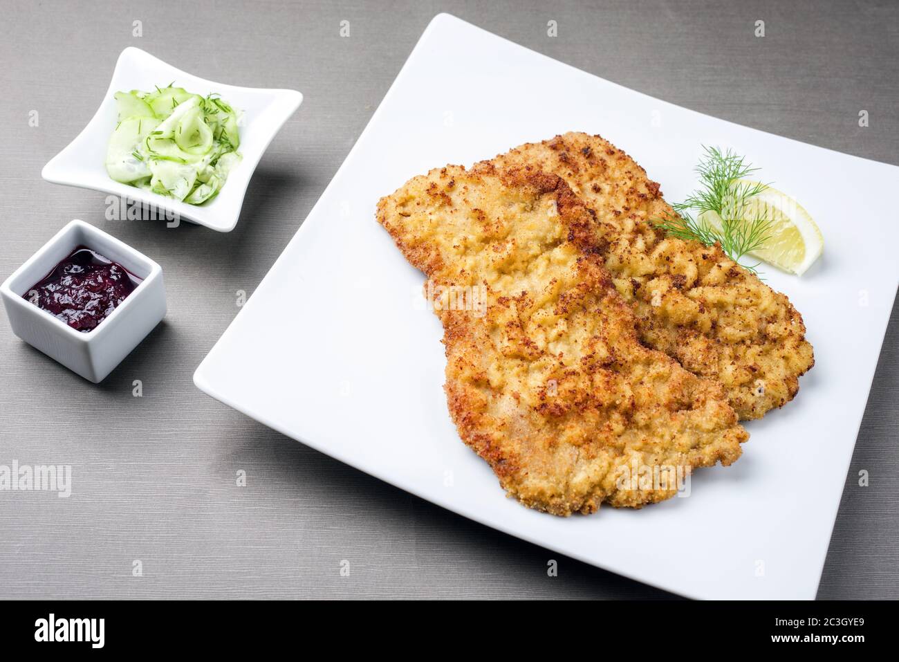 Traditional deep fried Wiener schnitzel from veal topside with cucumber ...