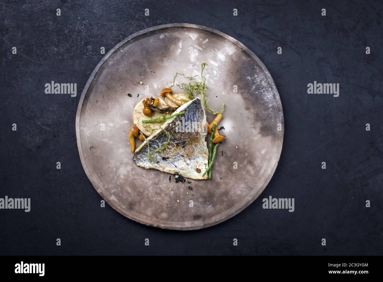 Gourmet fried gilthead fish filet with sliced dumpling Stock Photo - Alamy