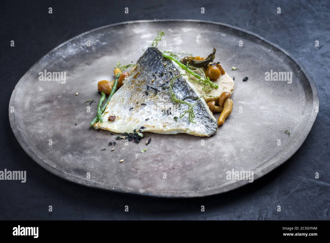 Gourmet fried gilthead fish filet with sliced dumpling Stock Photo - Alamy