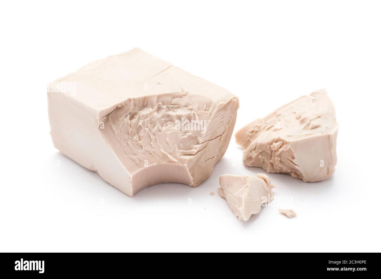 A stick of fresh brewer's yeast on white background. Mostly used for ...