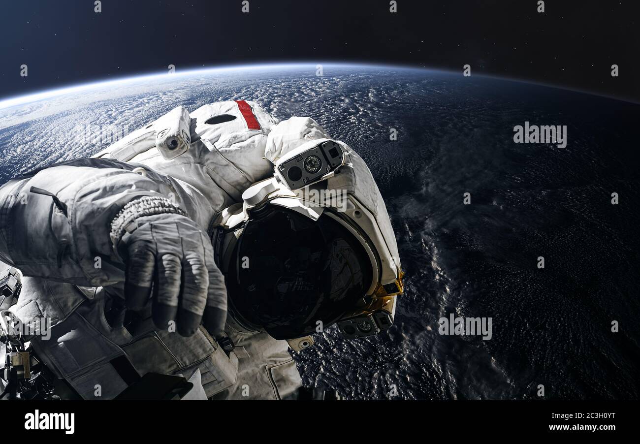 Astronaut in orbit of the Earth. Solar system Stock Photo - Alamy