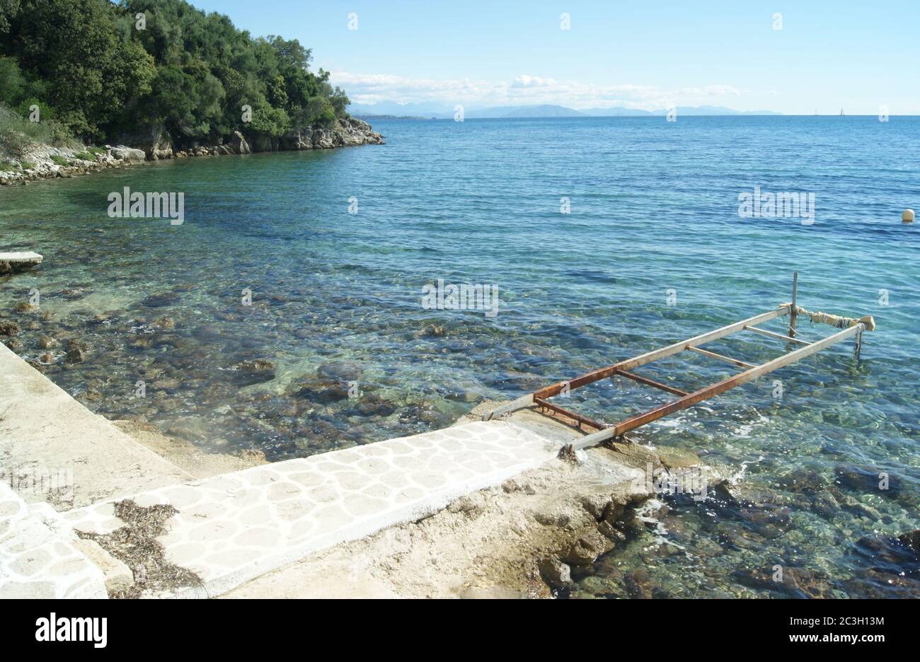 An old metal jetty on the coast at the beautiful Greek island of Corfu ...