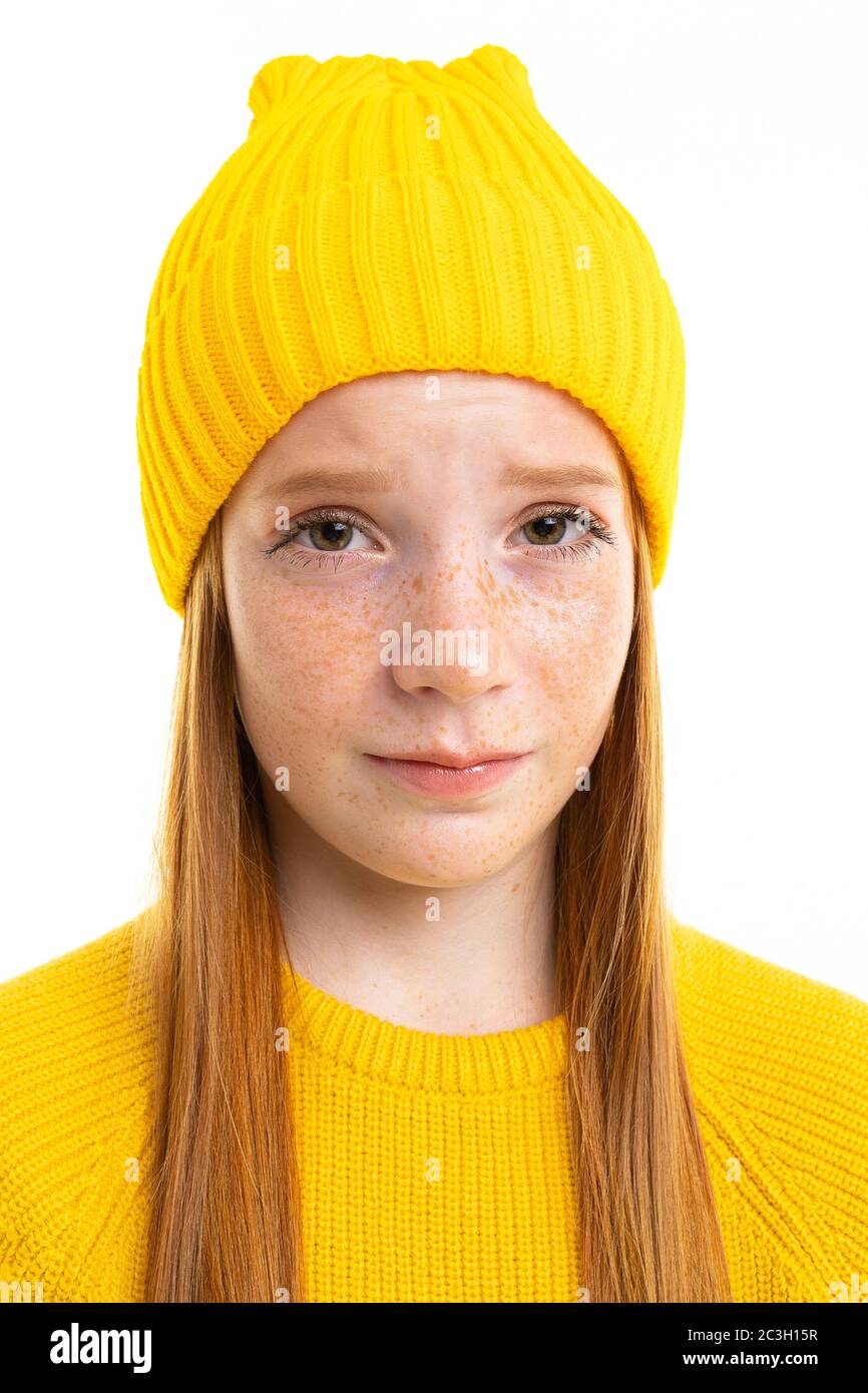 sad european red-haired girl with freckles close-up on a white ...