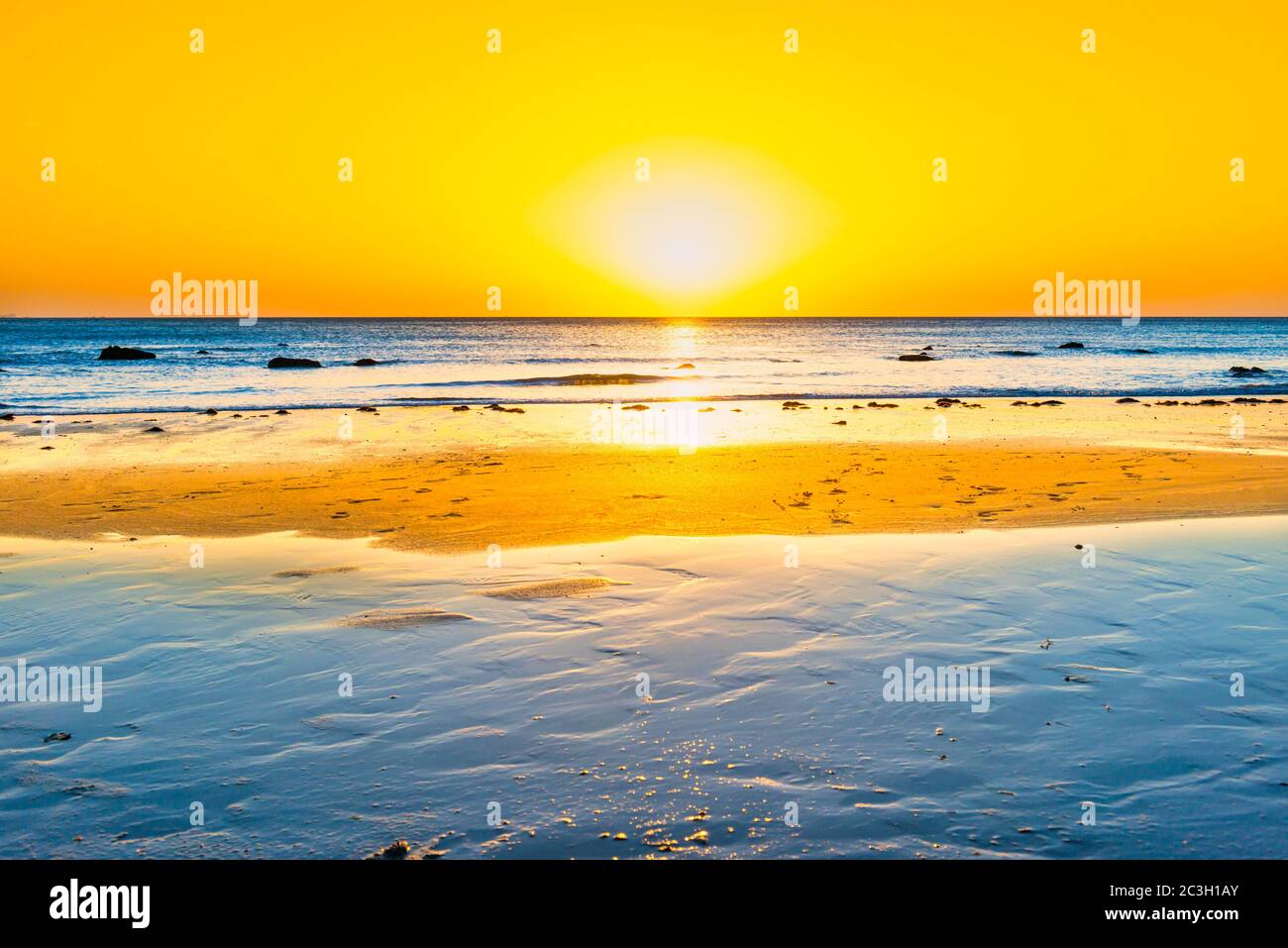 Sunset on beautiful sand beach Stock Photo - Alamy