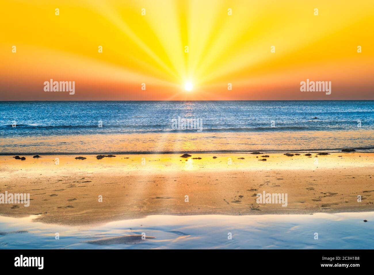 Sunset on beautiful sand beach Stock Photo - Alamy