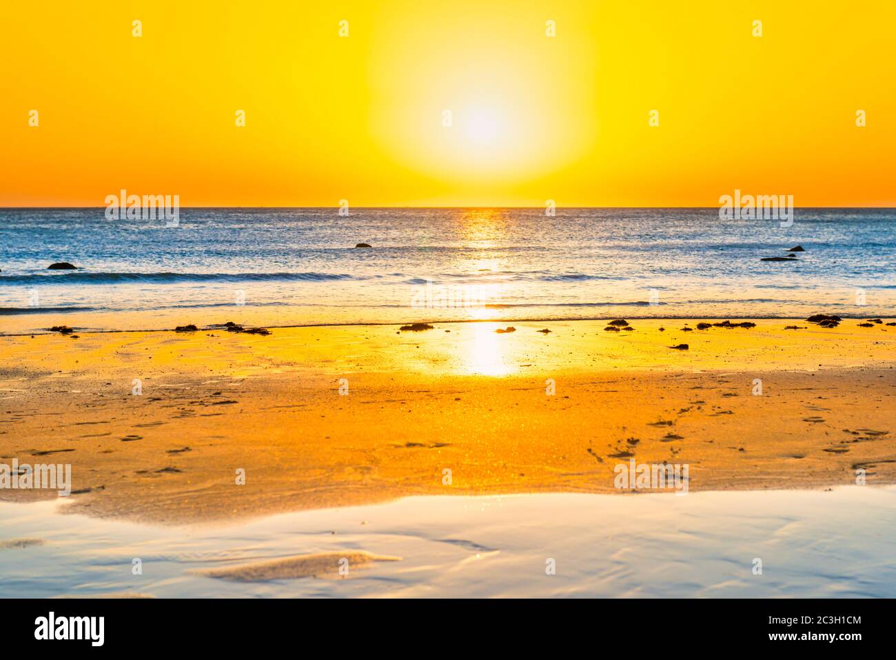 Sunset on beautiful sand beach Stock Photo - Alamy