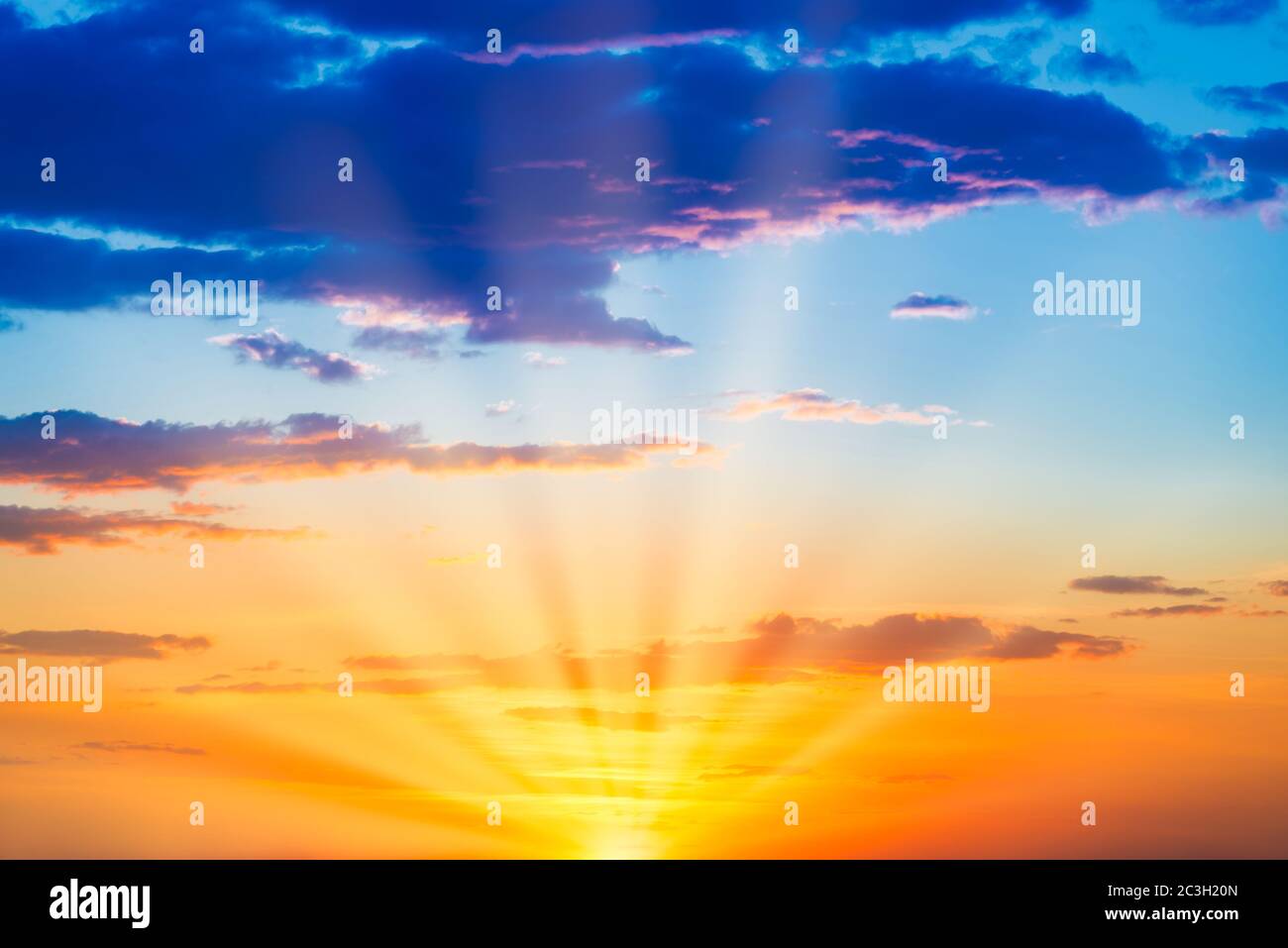 Sunset sky with sun and clouds Stock Photo - Alamy