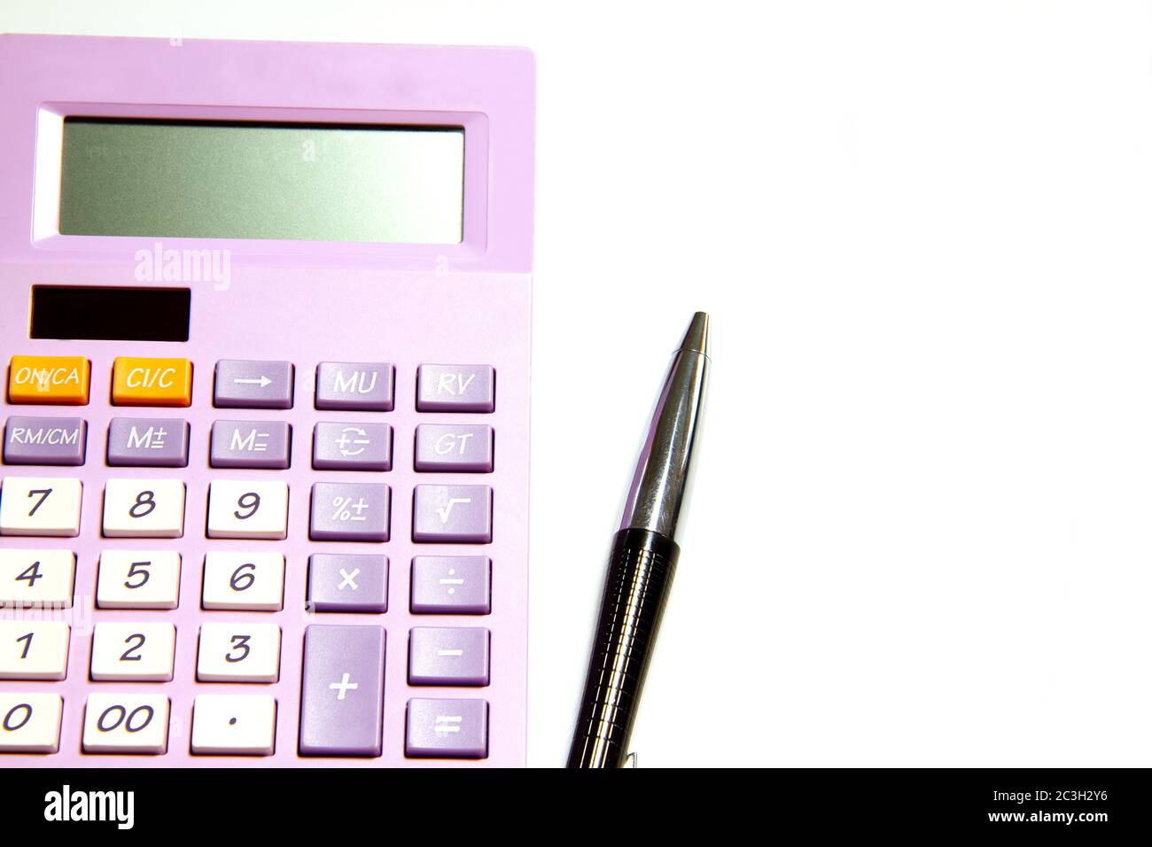 Purple calculator and pen on a white background Stock Photo - Alamy