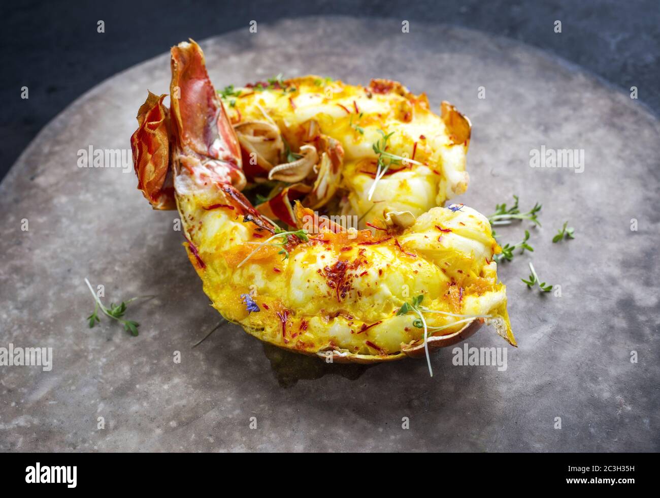 Traditional barbecue spiny lobster tail sliced and offered with saffron ...