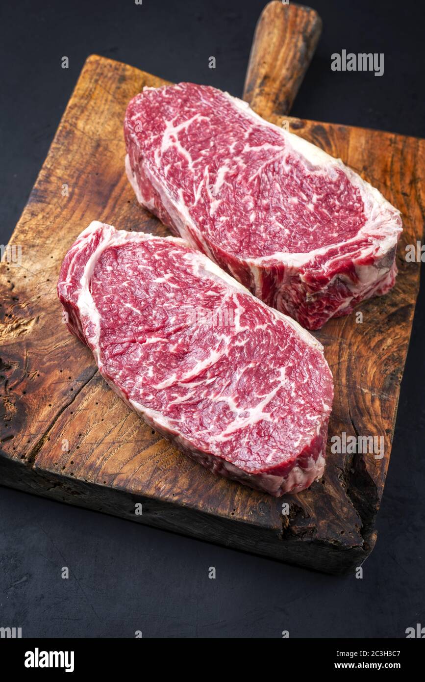 Raw dry aged wagyu entrecote beef steak roast as closeup on a rustic ...